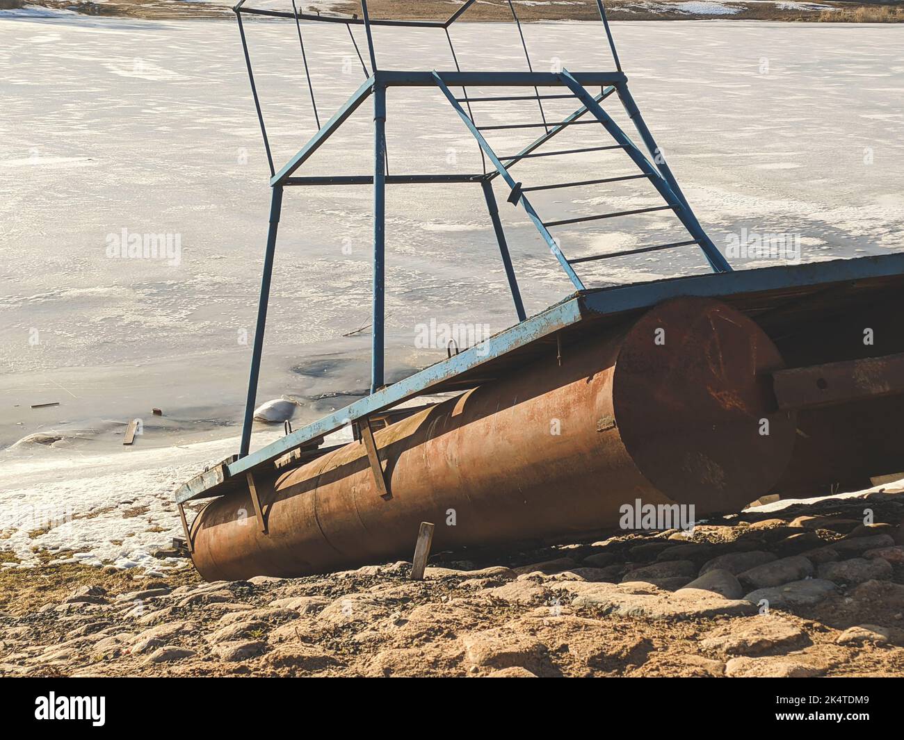 Small pontoon boat with iron construction on the paved shore Stock ...