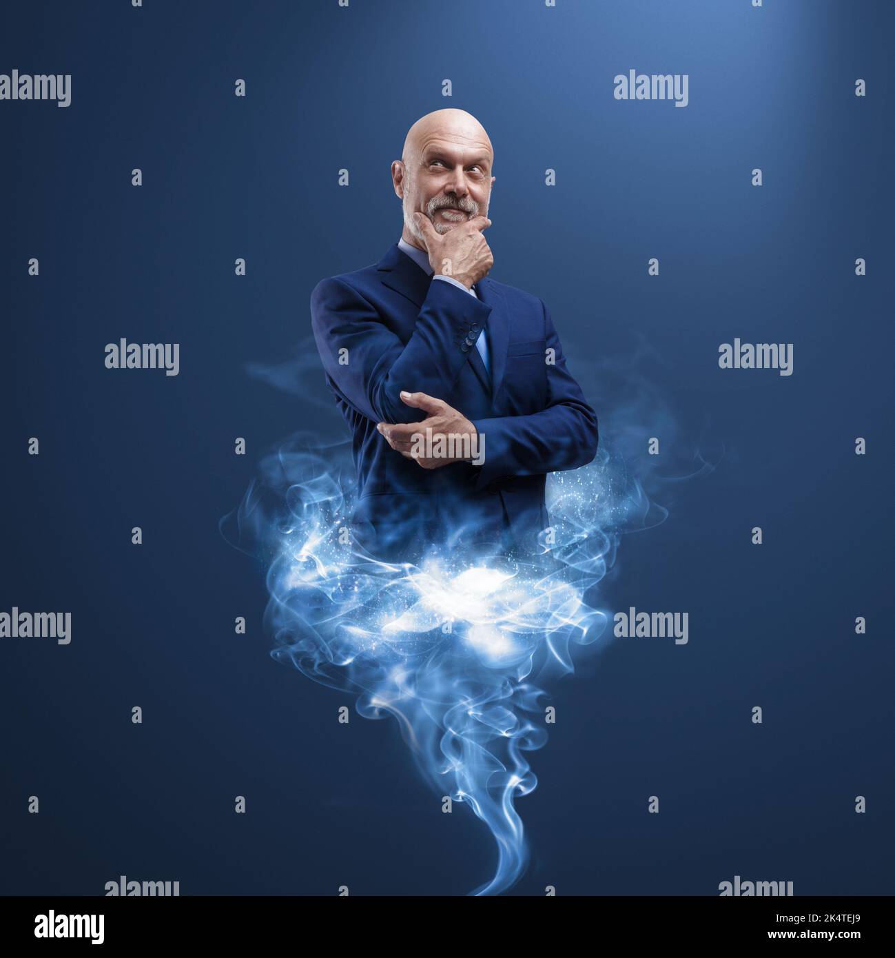 Businessman genie appearing and smoke, he is thinking with hand on chin ...