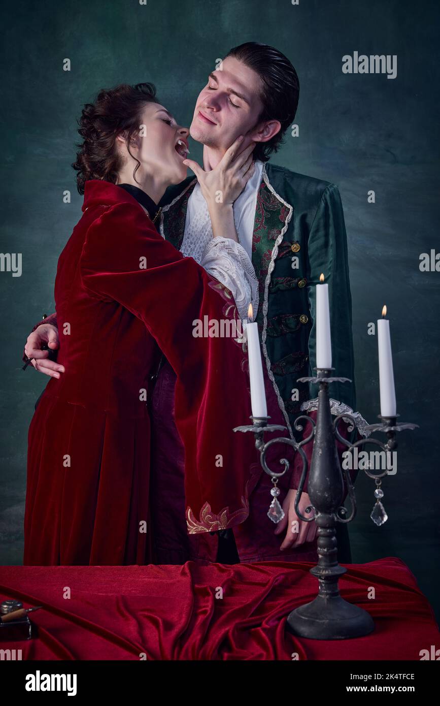 Portrait of woman in image of fearful vampire bites young man on neck ...