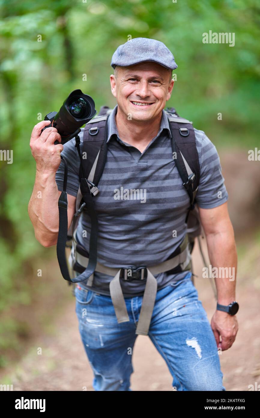 Professional travel and nature photographer hiking in the forests with ...