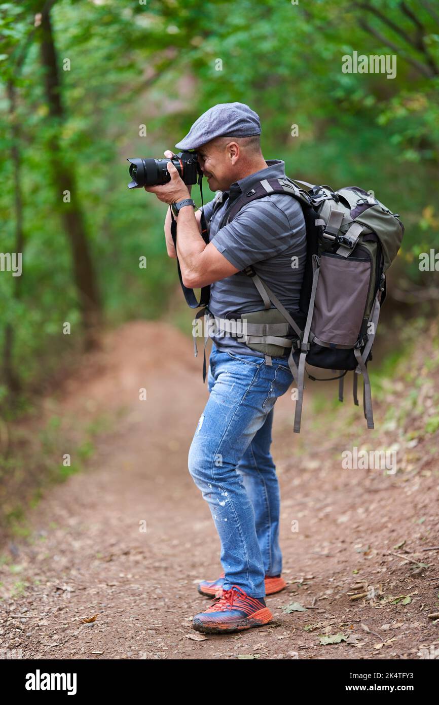 Professional travel and nature photographer hiking in the forests with ...
