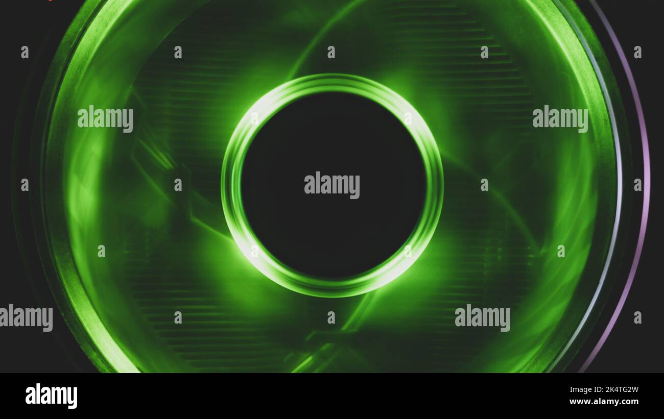 Computer cooling fan with green light close up. cooler in action with ...