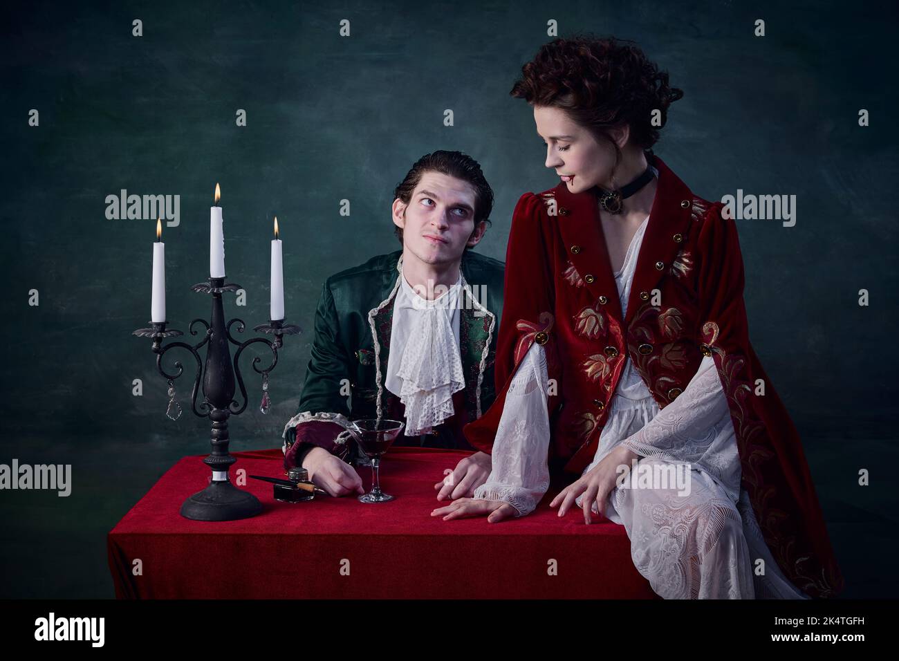 Portrait of elegant woman and man in image of medieval vampires having ...