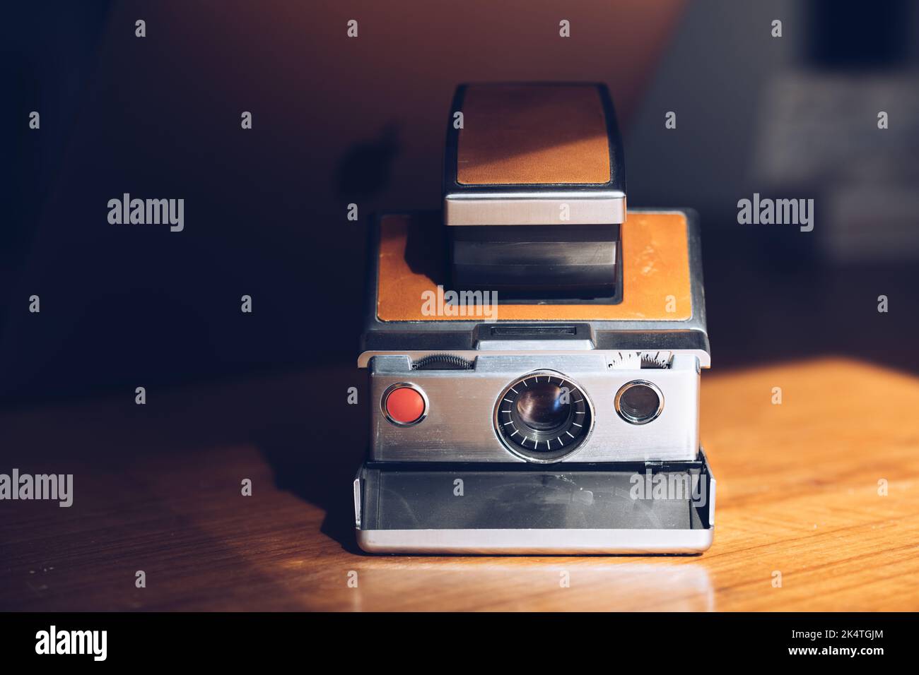 Retro instant camera on a midcentury wooden desk. Polaroid Stock Photo ...