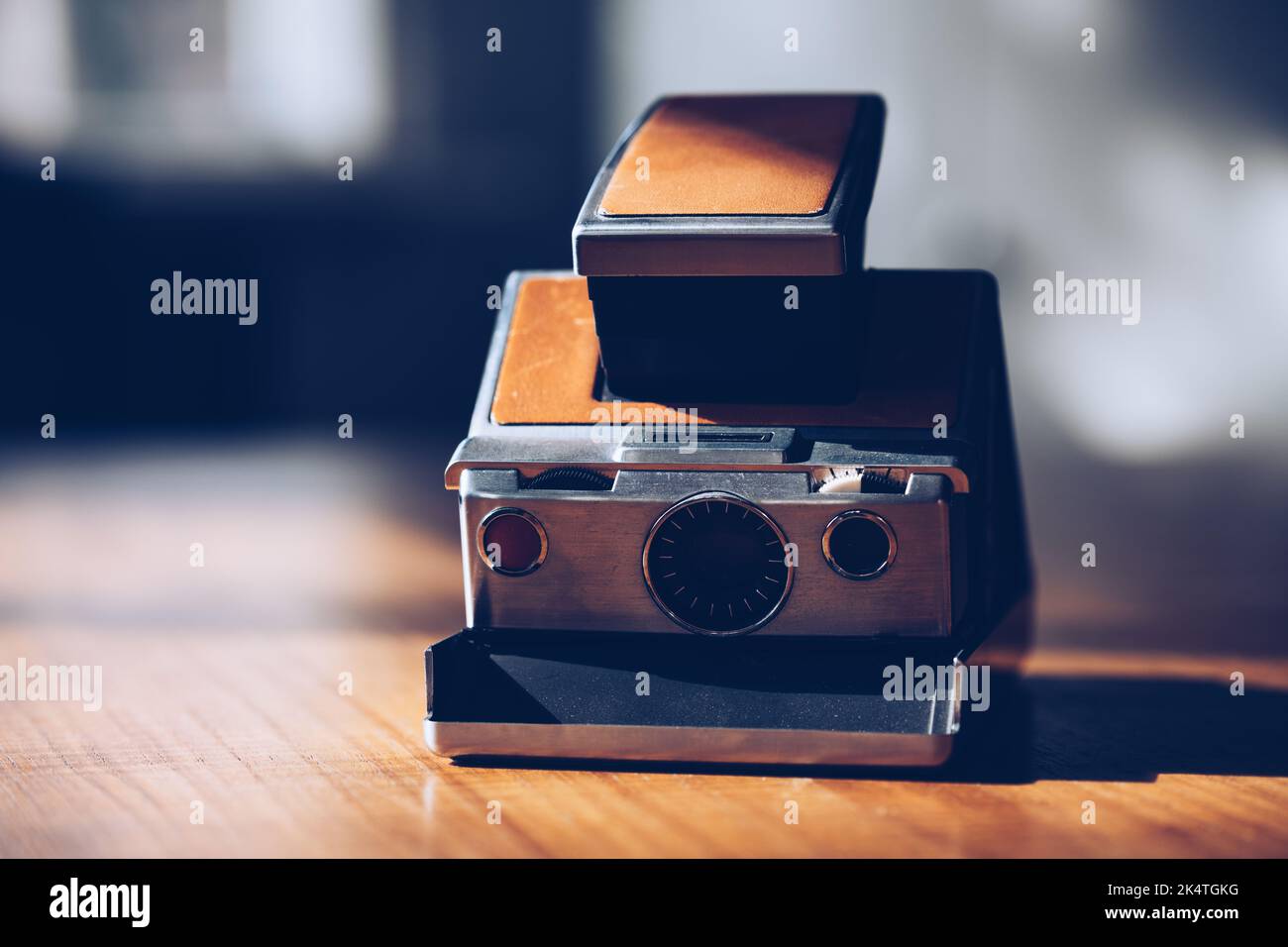 Retro instant camera on a midcentury wooden desk. Polaroid Stock Photo ...