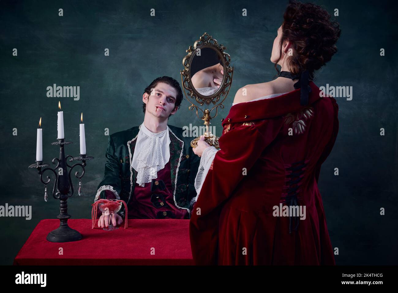 Portrait of man in image of vampire and woman looking in mirror on her ...