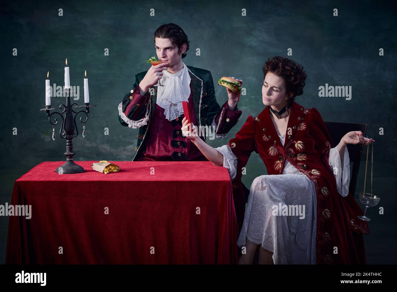 Portrait of man and woman in image of vampires over dark green ...