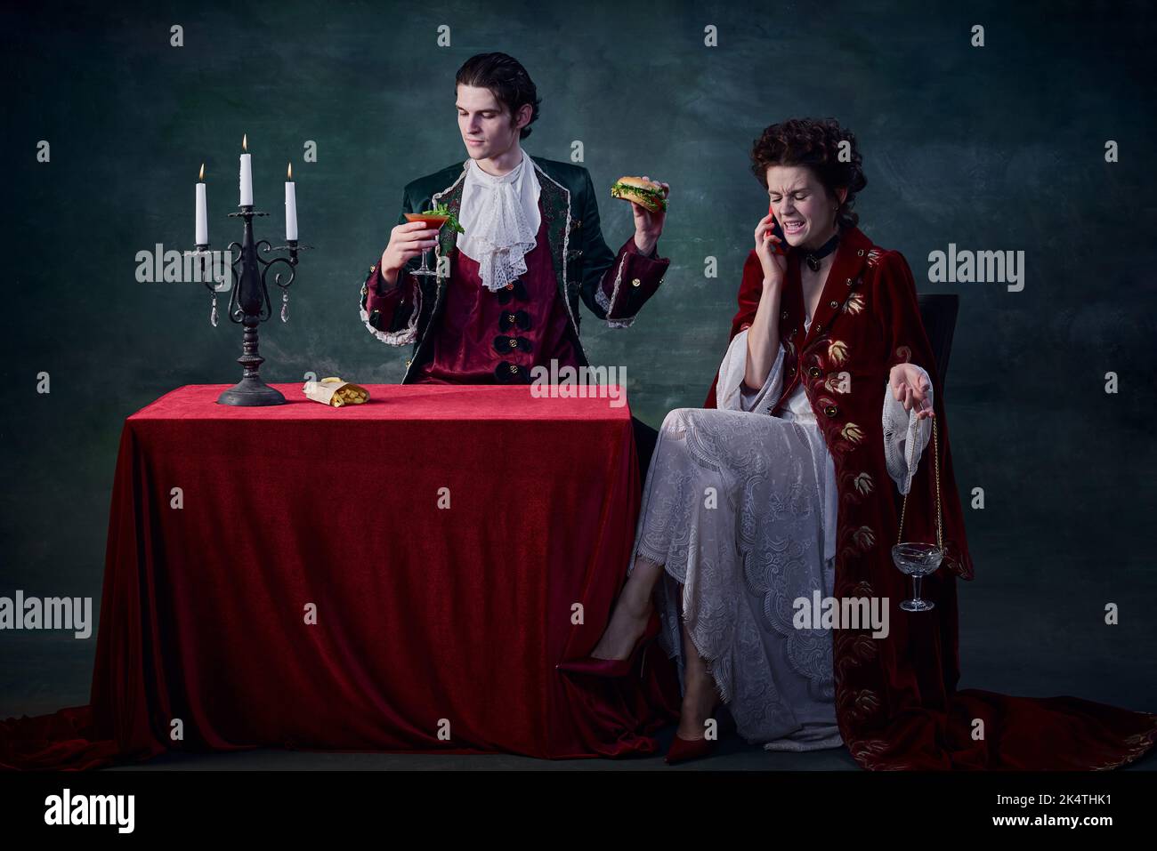 Portrait of man and woman in image of medieval vampires over dark green ...