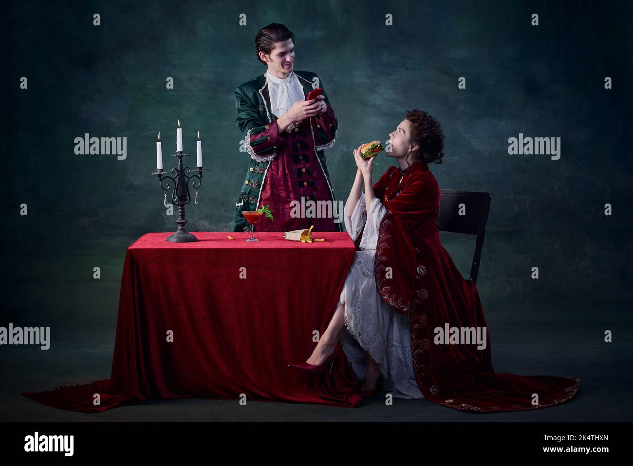 Portrait of man and woman in image of vampires over dark green ...