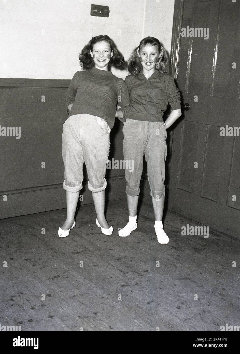 1961, historical, standing in a corner of a room, two teenage girls in ...