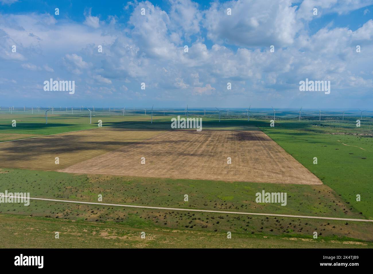 Row of windmill renewable energy turbines on a wind farm in the Texas ...