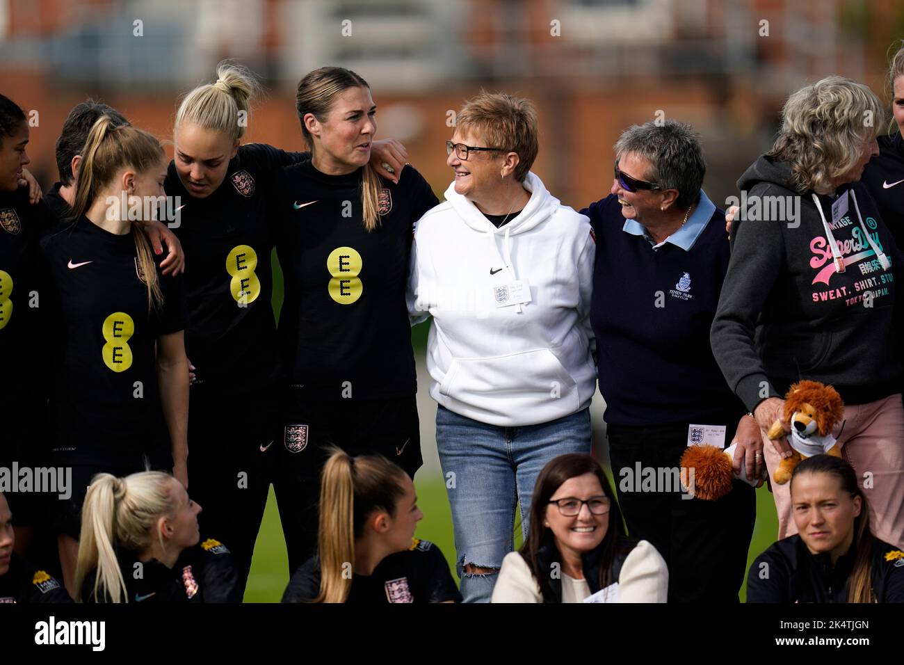 England players pose for a group photograph with former Lionesses Tracy ...