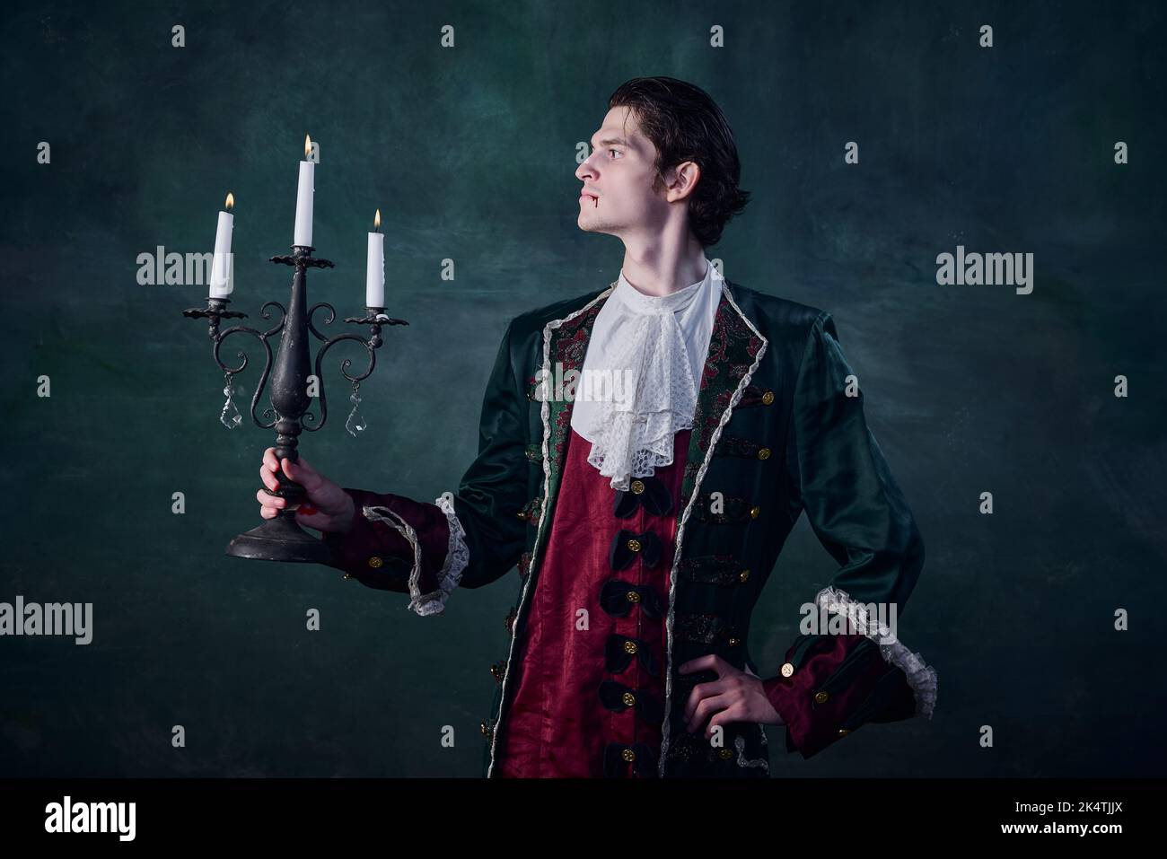 Portrait of man in noble medieval costume in image of vampire holding ...