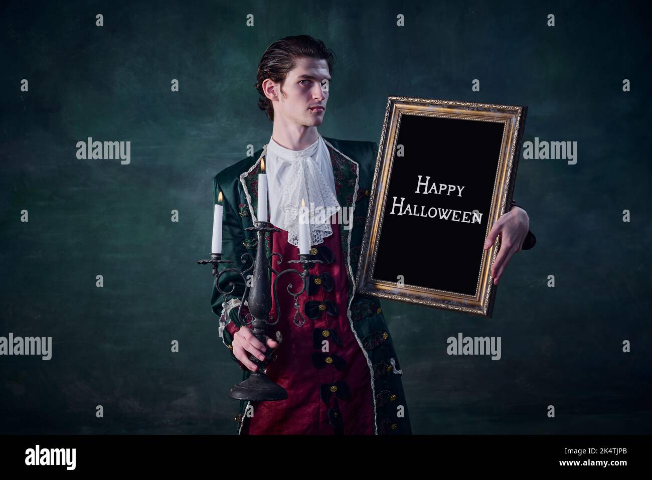 Portrait of man in noble medieval costume in image of vampire holding ...