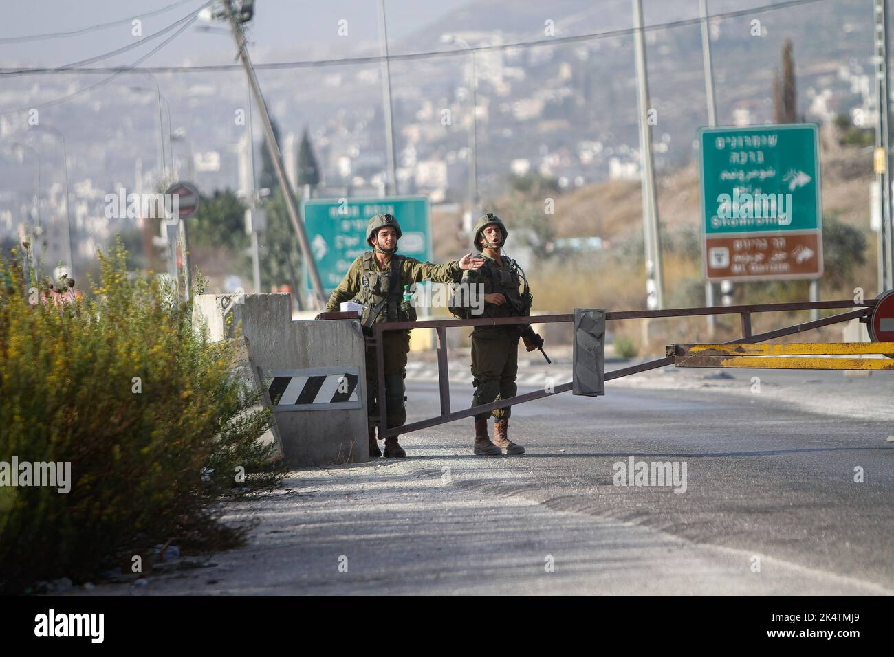 Israeli soldiers guard against Palestinians while Jewish settlers block Hawara Checkpoint, the ...