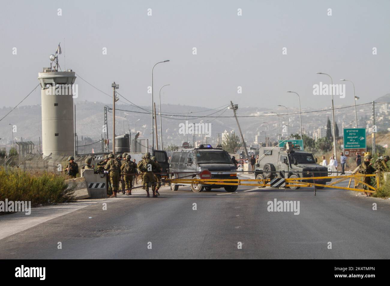Israeli soldiers guard against Palestinians while Jewish settlers block Hawara Checkpoint, the ...