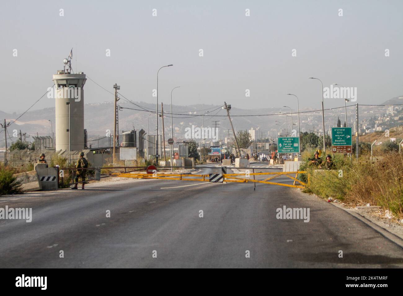 Israeli soldiers guard against Palestinians while Jewish settlers block Hawara Checkpoint, the ...