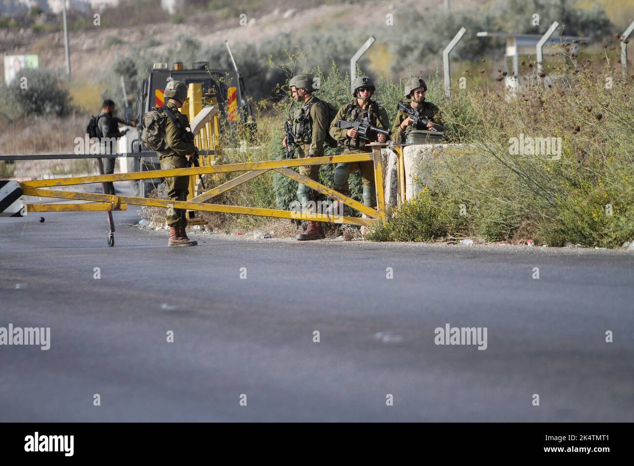 Israeli soldiers guard against Palestinians while Jewish settlers block Hawara Checkpoint, the ...