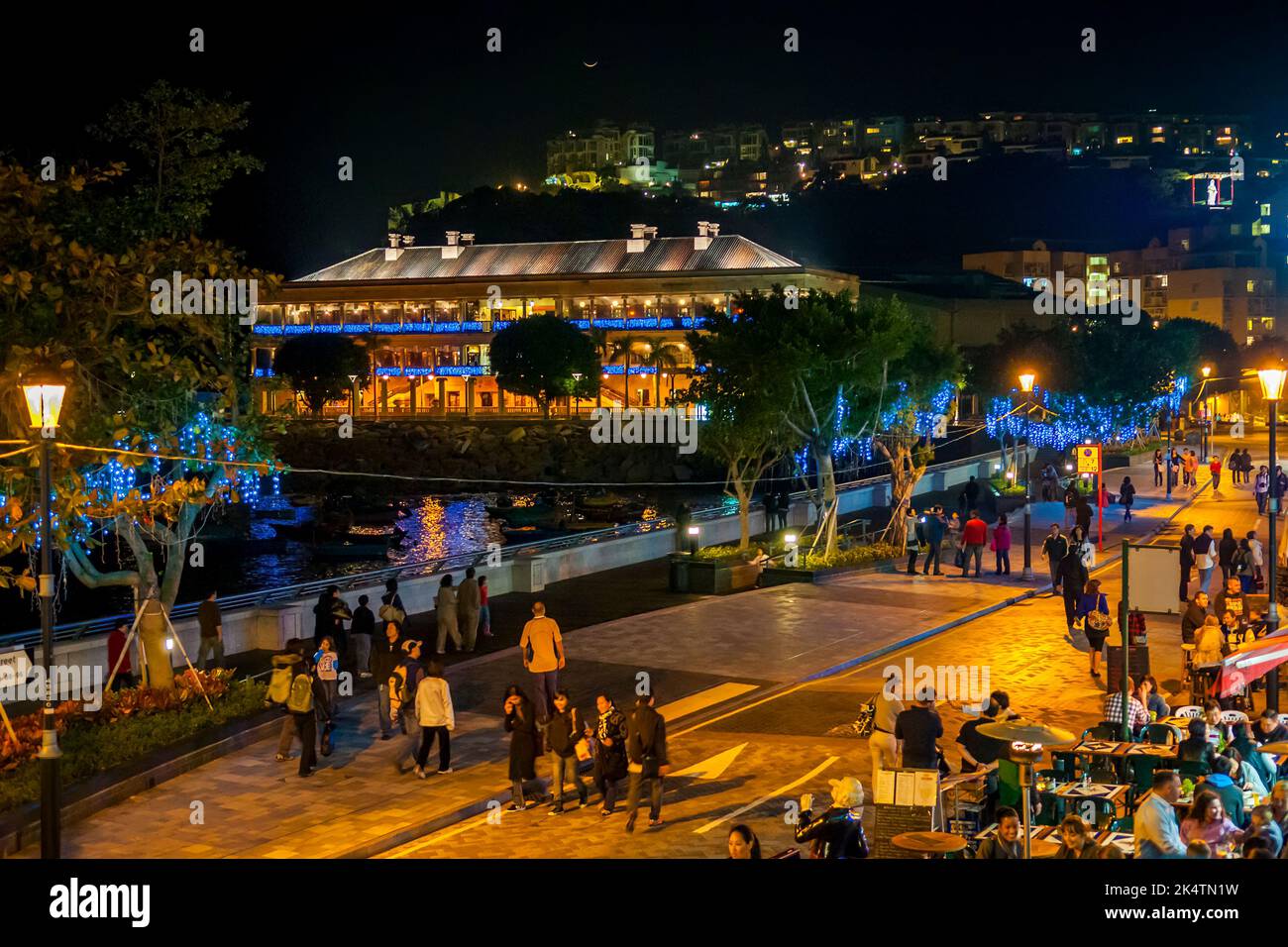 Tourists enjoy the promenade and al fresco dining of Stanley waterfront ...