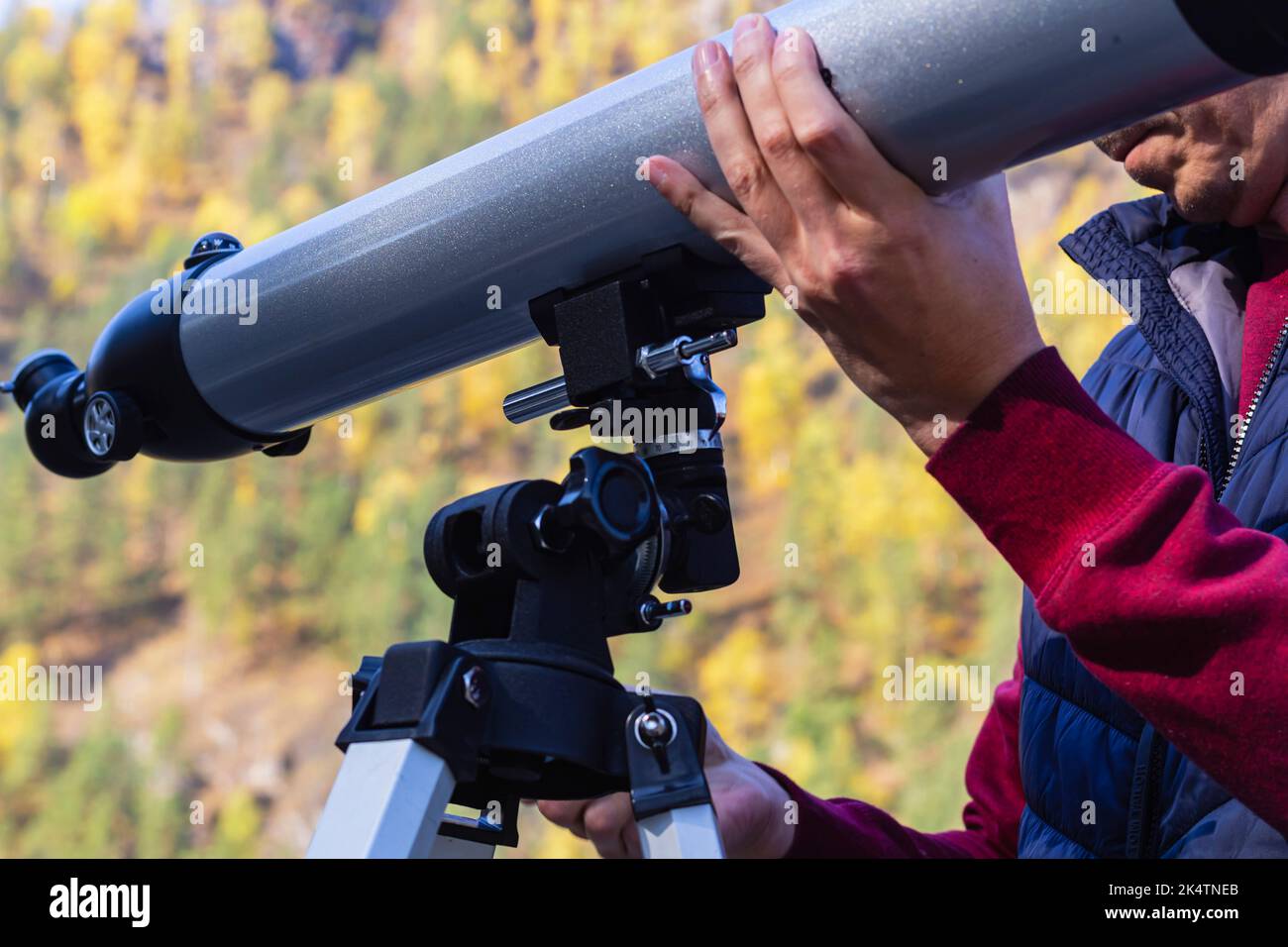 Man's hand holds large gray telescope, watch celestial body. Optical ...