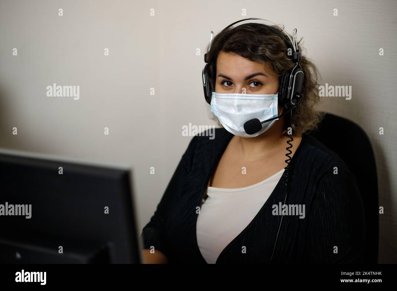 A call center agent working on the support hotline in the office ...