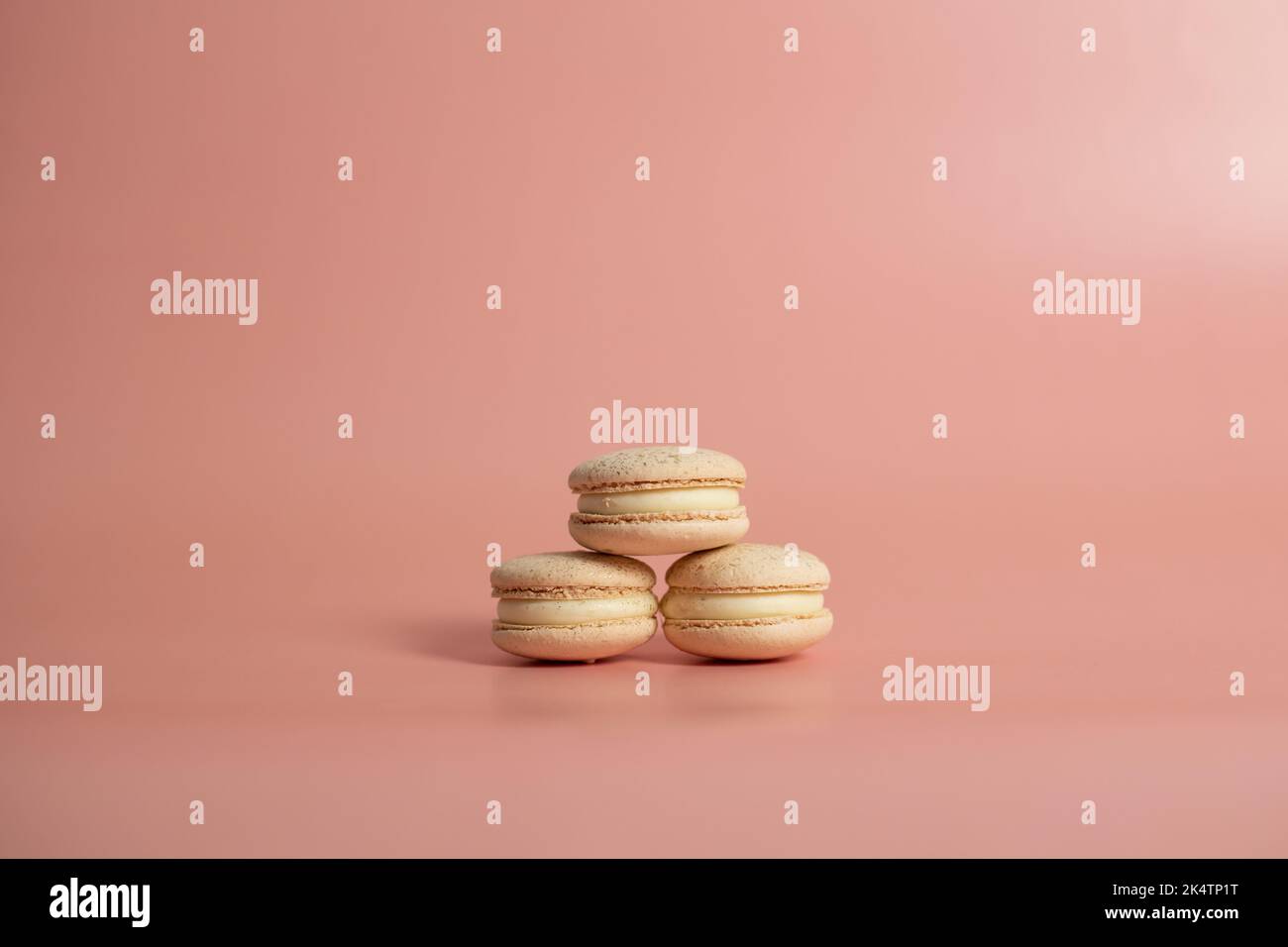 Round beautiful sweets macaroni on a pink background. Still life with ...