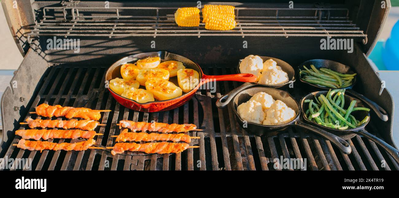 preparing dinner on a gas grill Stock Photo - Alamy