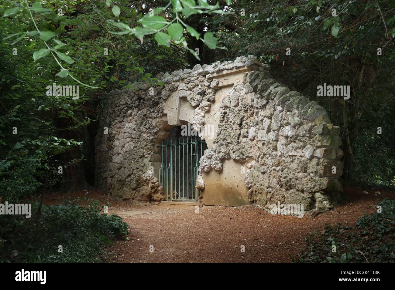 An entrance of an old rocky building in a dense forest Stock Photo - Alamy