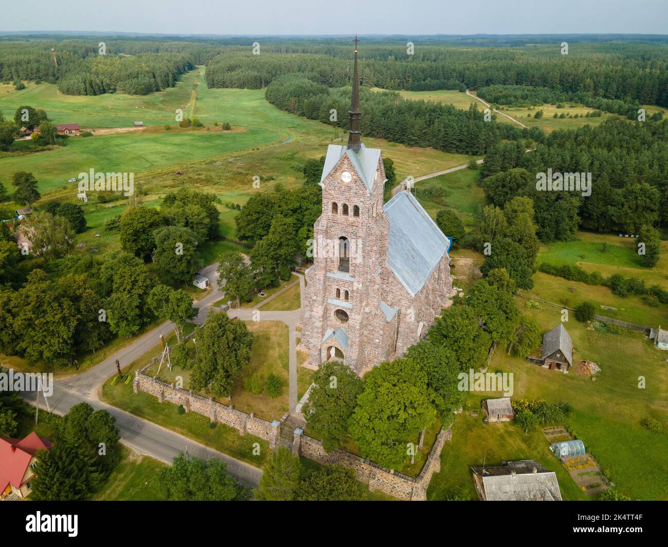 An aerial view of a historic old stone church in the rural green areas ...
