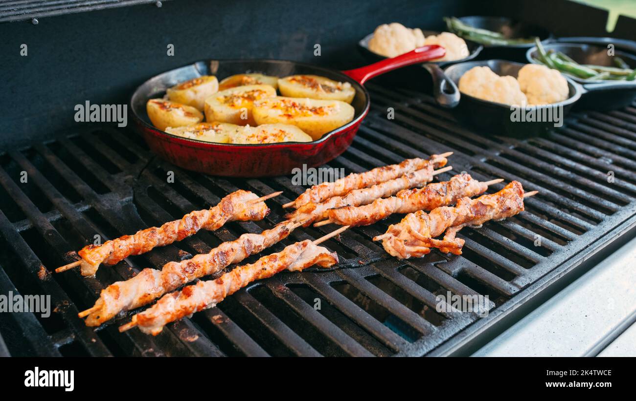 preparing dinner on a gas grill Stock Photo - Alamy
