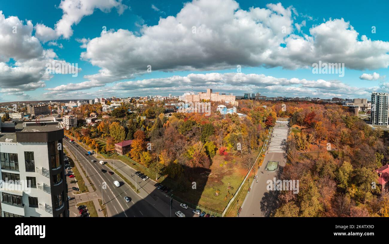 Aerial autumn Kharkiv Botanical Garden near streets with lively cars ...