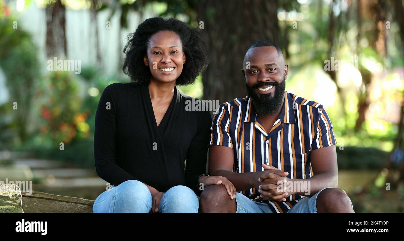 Young black couple sitting at park. Married African husband and wife ...