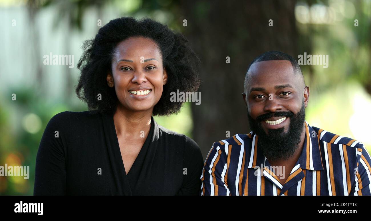 Young black couple sitting at park. Married African husband and wife ...