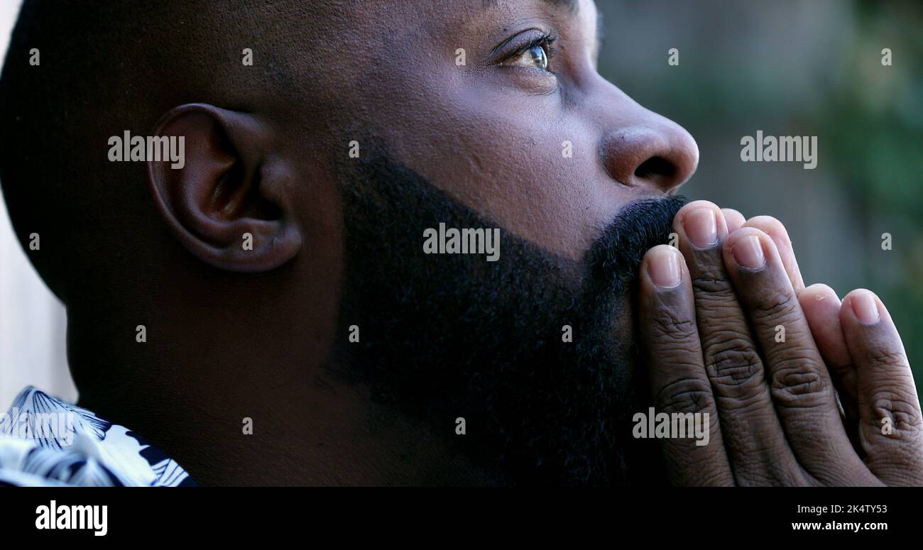 Upset man, worried African person feeling stress and anxiety close-up ...