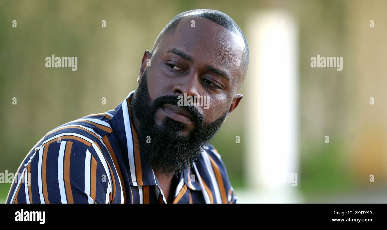 Thoughtful black African man thinking of solution Stock Photo - Alamy