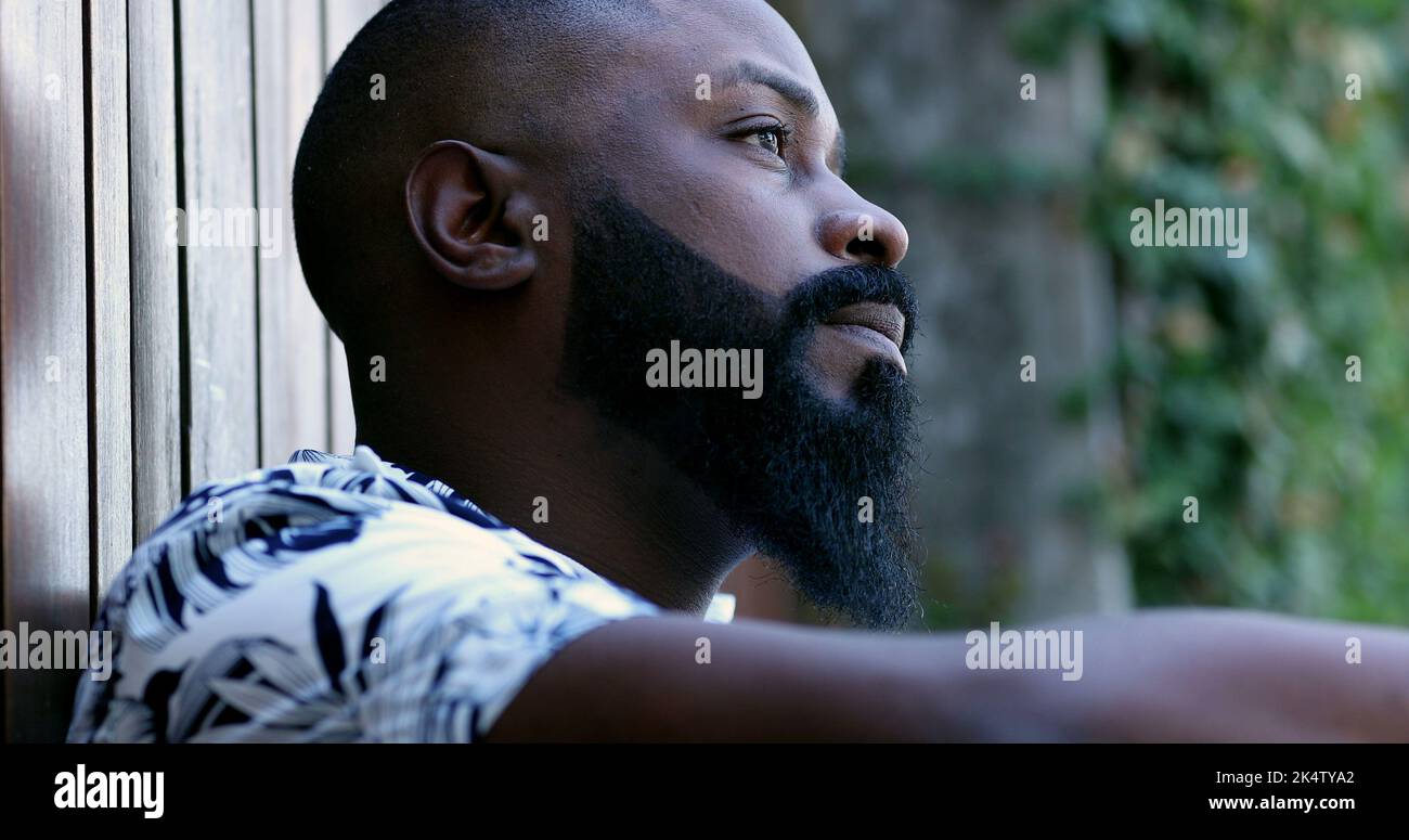 Stressed out black man sitting on floor feeling worry Stock Photo - Alamy