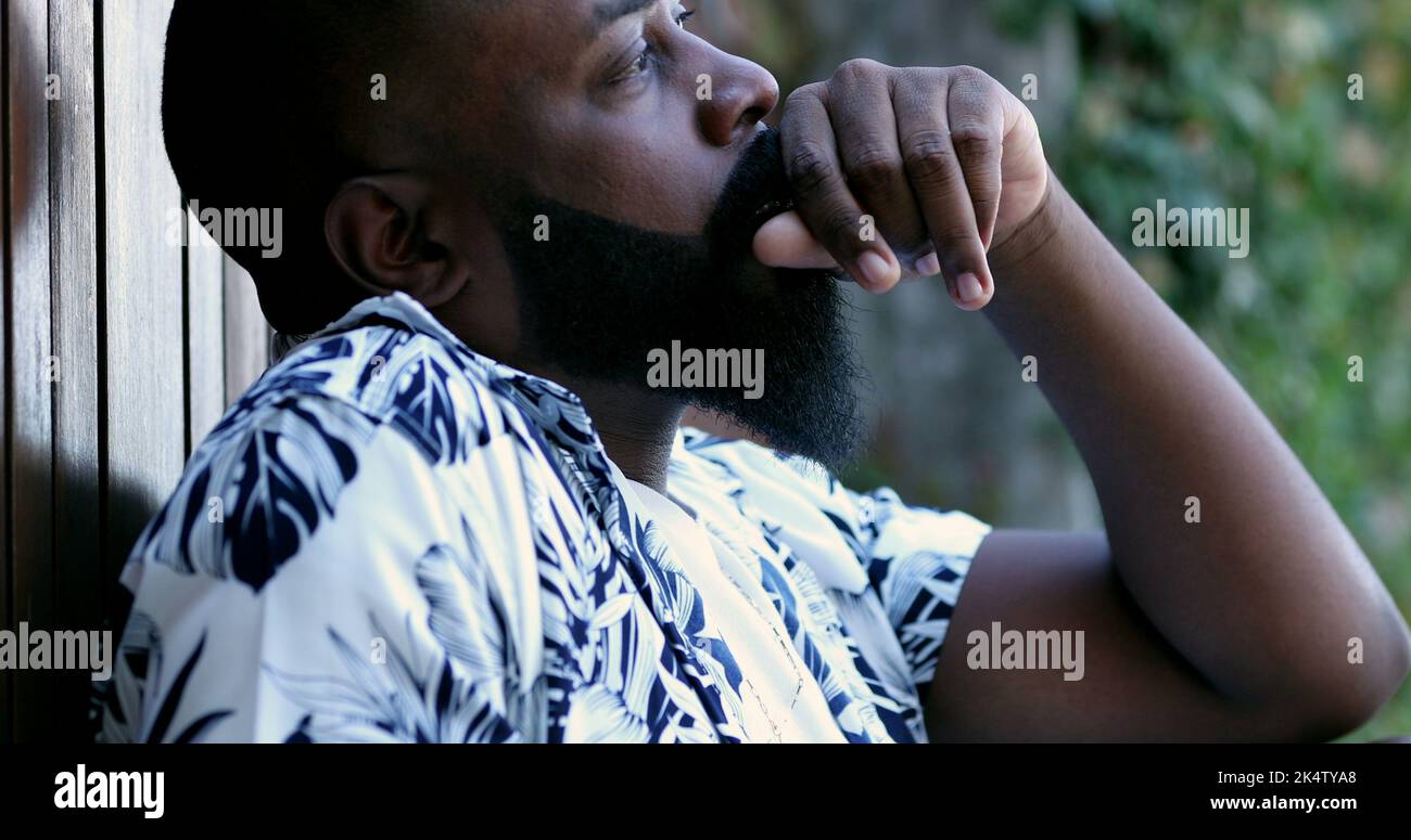 Stressed out black man sitting on floor feeling worry Stock Photo - Alamy