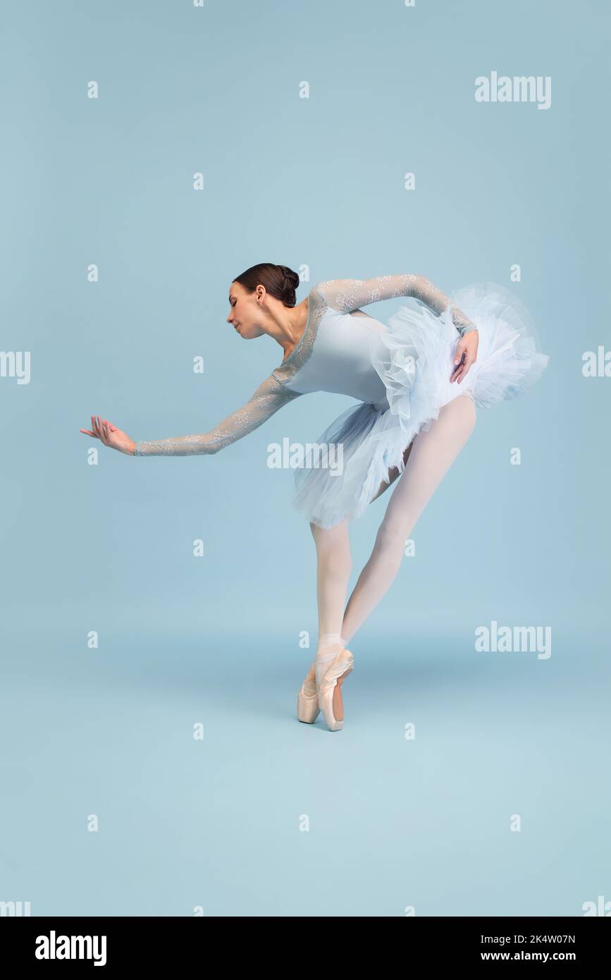Portrait of tender young ballerina dancing, performing isolated over ...