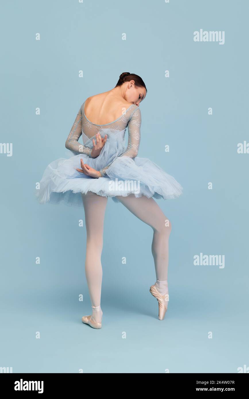 Portrait of tender young ballerina dancing, performing isolated over ...