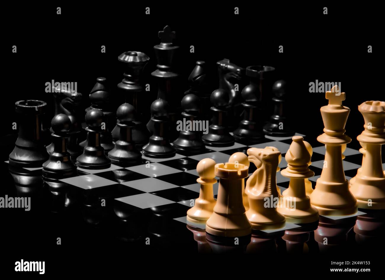 Close up of Chess pieces on a reflective mirror board surface with a ...