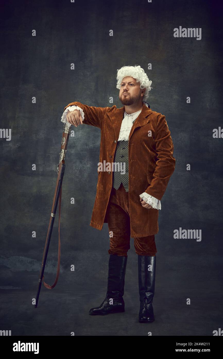 Creative portrait of retro style hunter in vintage hunting clothing ...