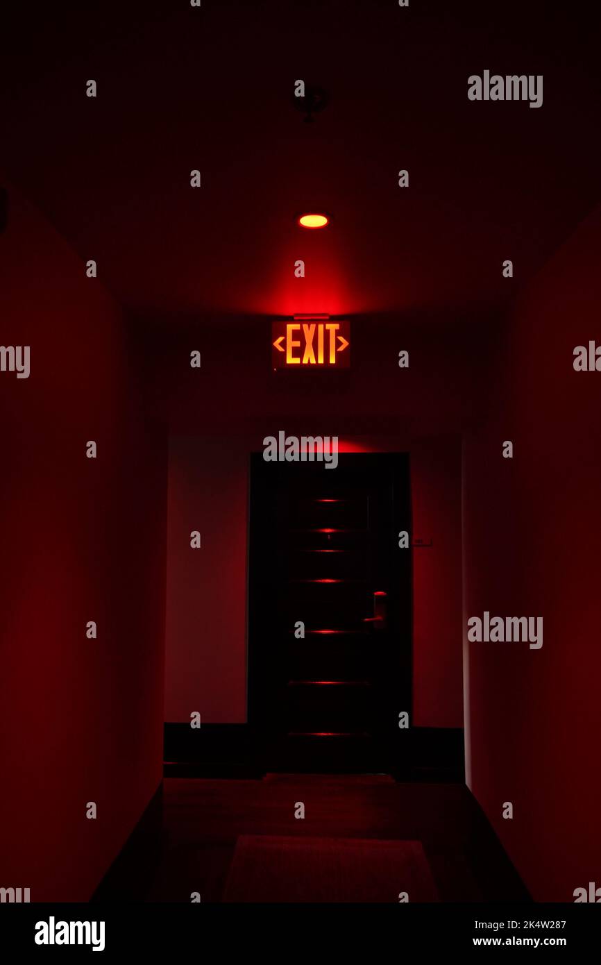 exit red light sign on black background Stock Photo - Alamy