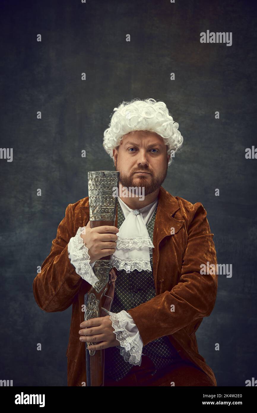Creative portrait of retro style hunter in vintage hunting clothing ...