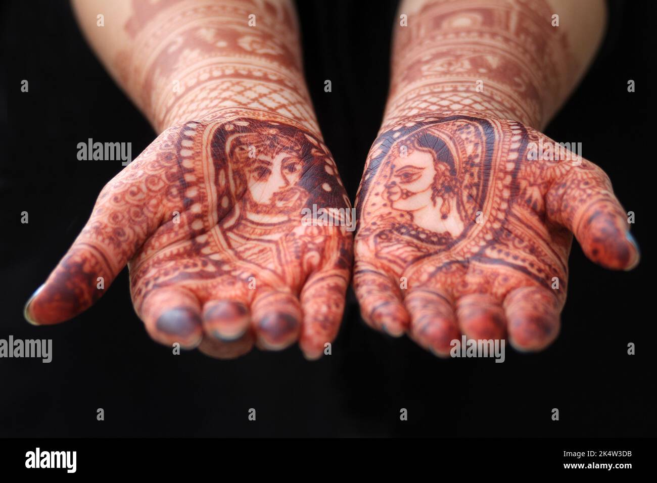 A close-up shot of hands showing decorative hand painting called Mehndi ...
