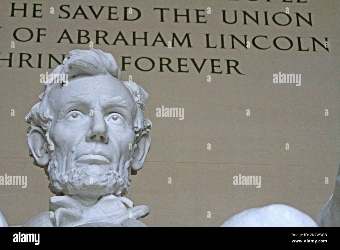 A close-up shot of the Lincoln Memorial statue with inscription in the ...