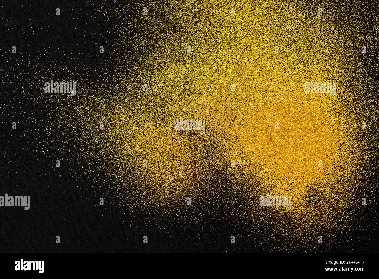 A minimal golden sand texture on a black background Stock Photo - Alamy