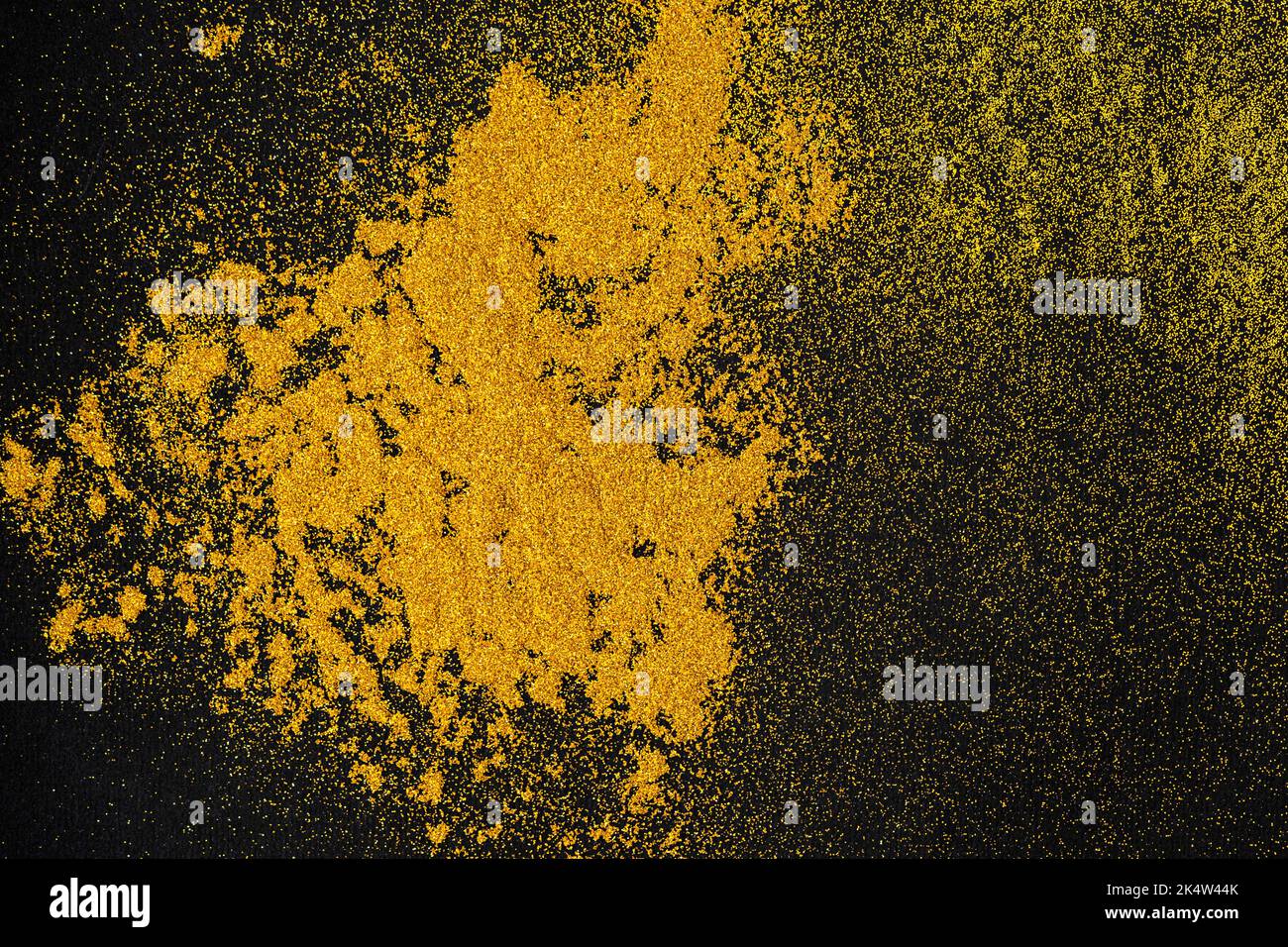 A minimal golden sand texture on a black background Stock Photo - Alamy