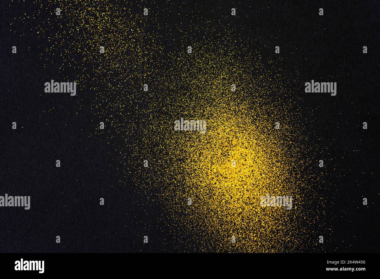 A minimal golden sand texture on a black background Stock Photo - Alamy
