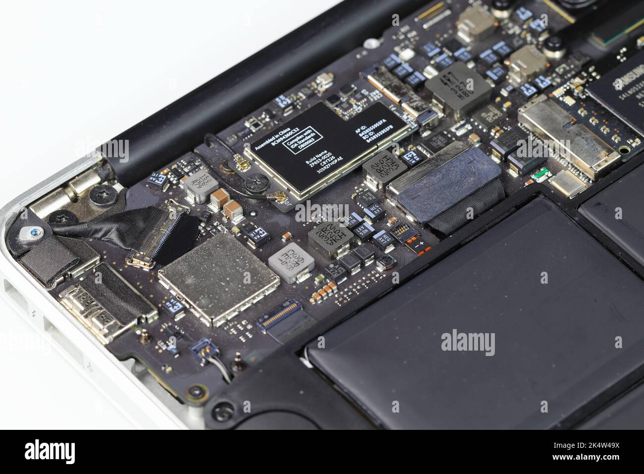 laptop computer being repaired, mainboard, wifi module, battery and SSD ...