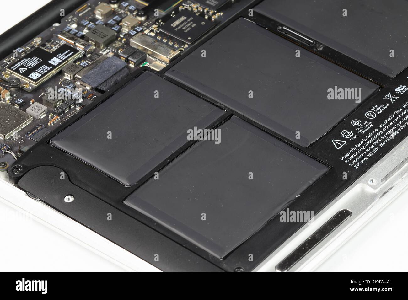 laptop computer being repaired, mainboard, wifi module, battery and SSD ...